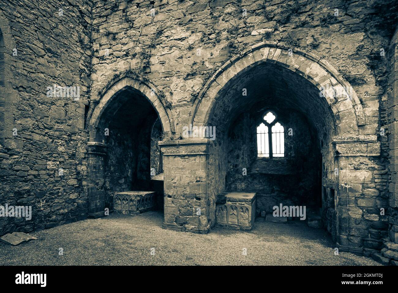 Historical ancient stone castle with arch windows and concrete banches ...