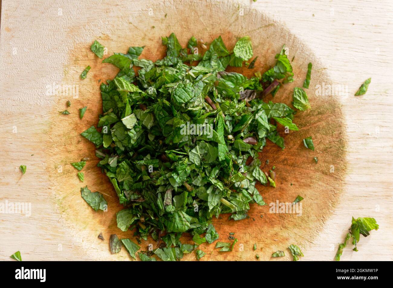 Mint has been finely chopped using a Mezzaluna double bladed knife on ...