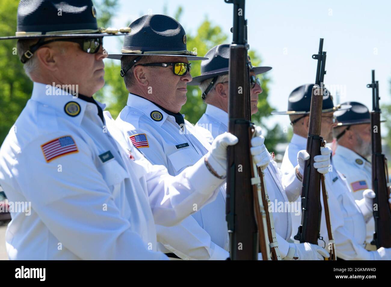 Members of the American Legion Post 10 Honor Guard render a rifle ...