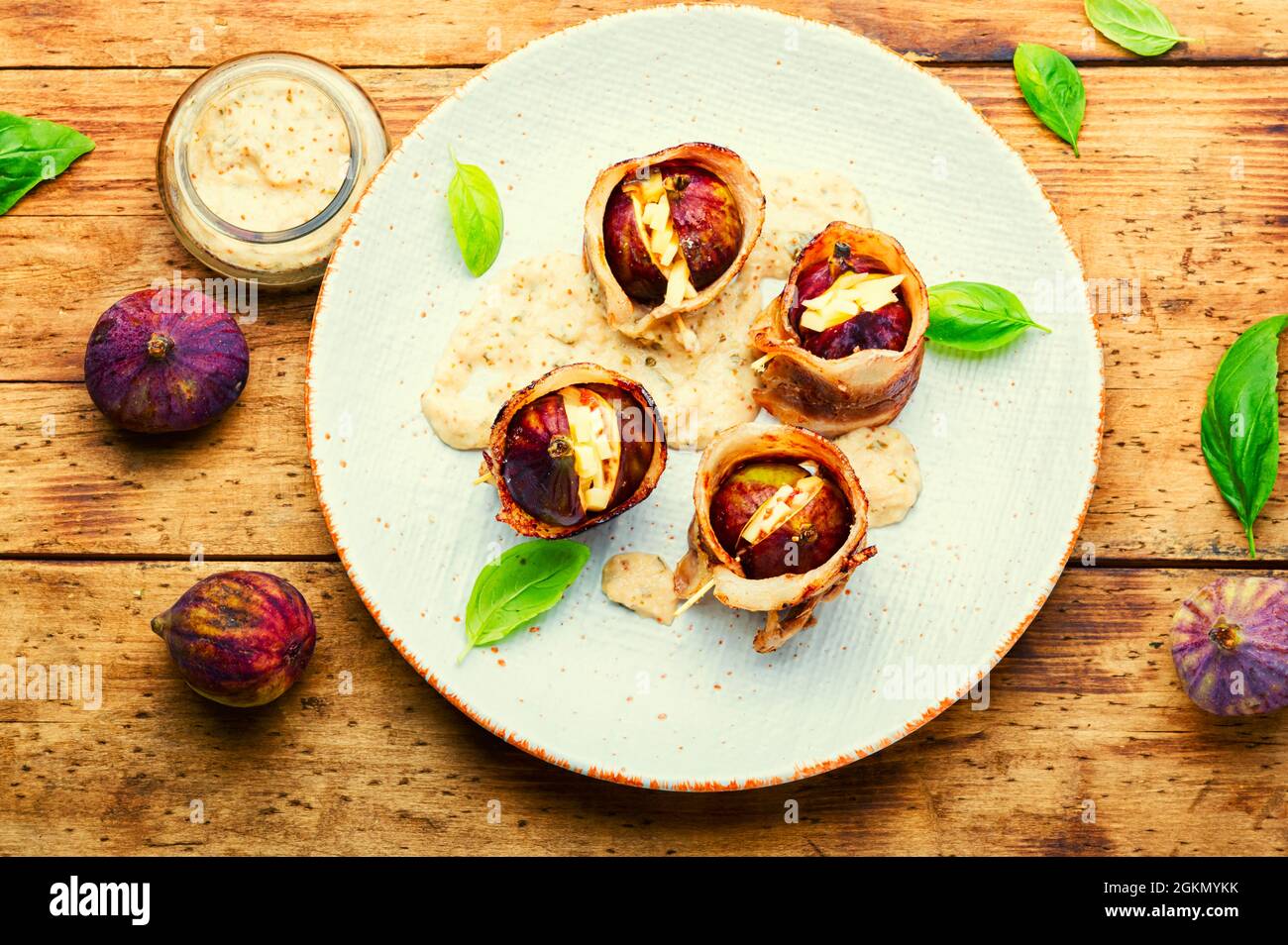 Figs wrapped in fried bacon stuffed with goat cheese.Baked figs Stock ...