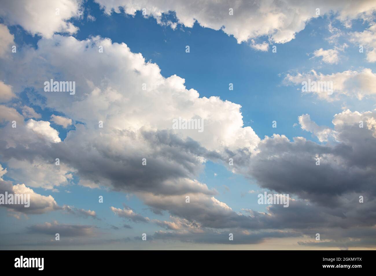 Heavy dark clouds on blue sky background, Sunbeams through the clouds ...