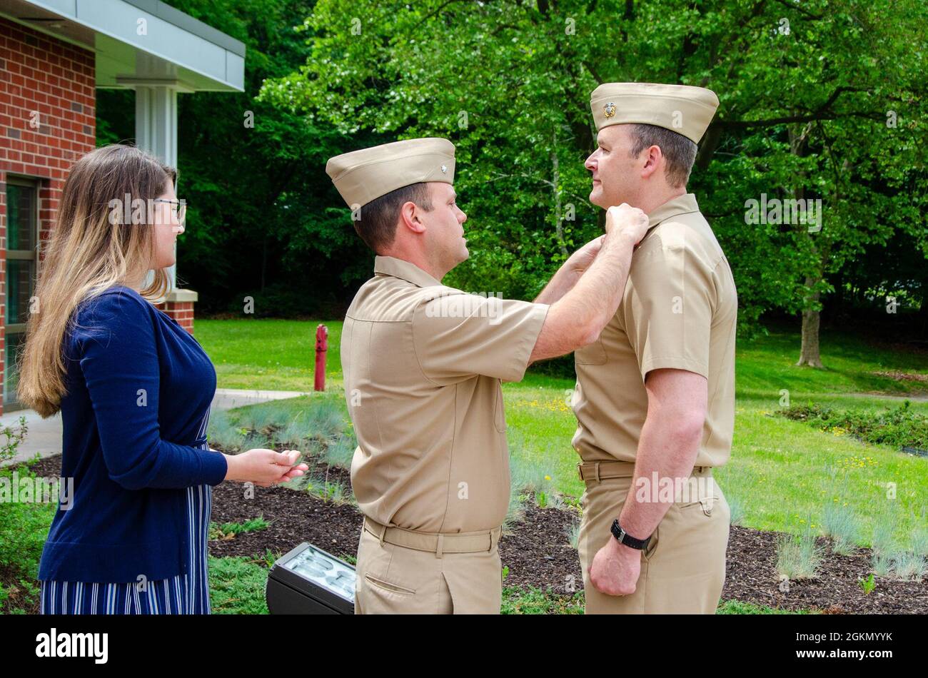Cmdr. Michael Graham pins on the rank insignia onto Lt. Cmdr. Rick ...