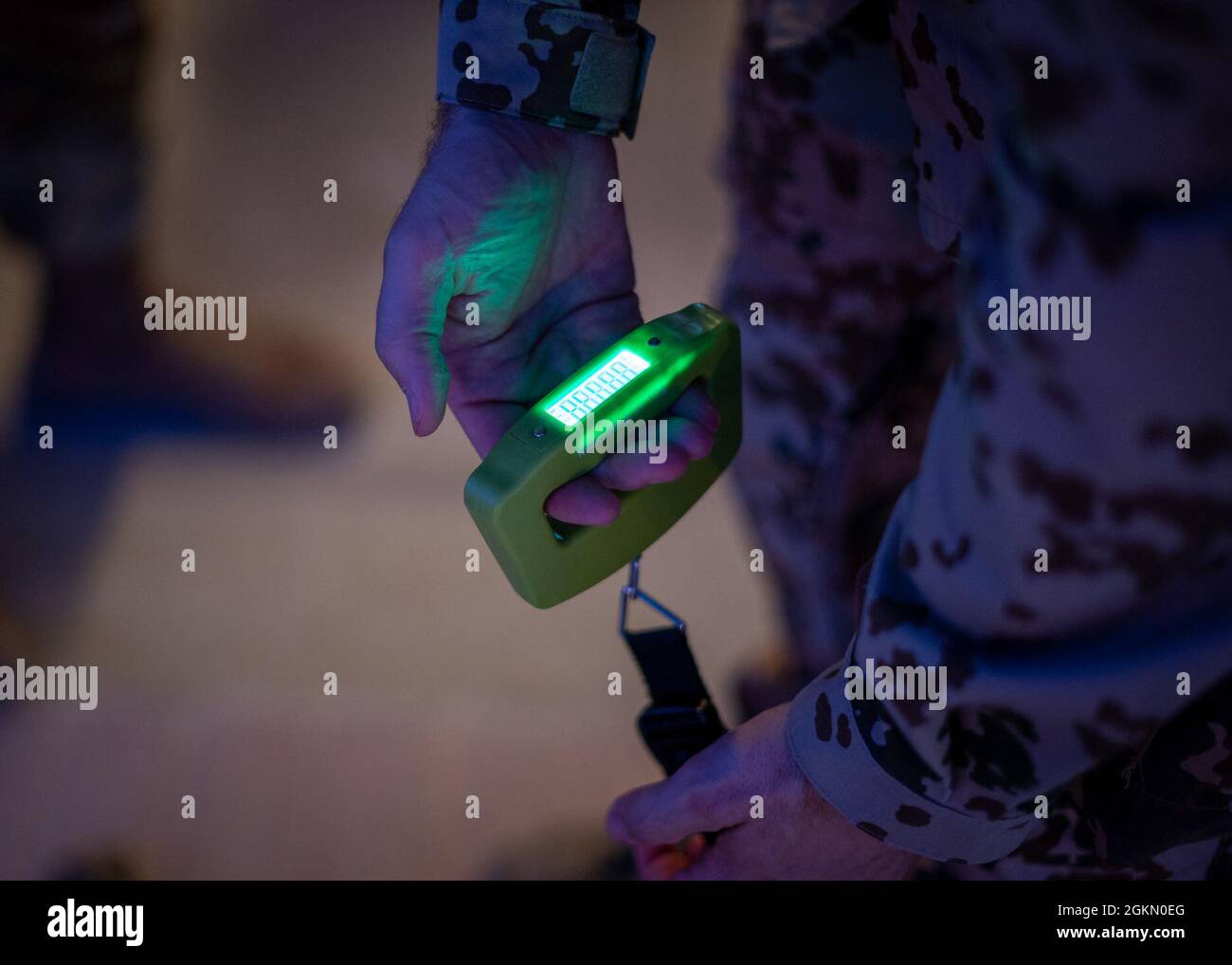 A member of the U.S. Air Forces Central German detachment weighs a ruck ...