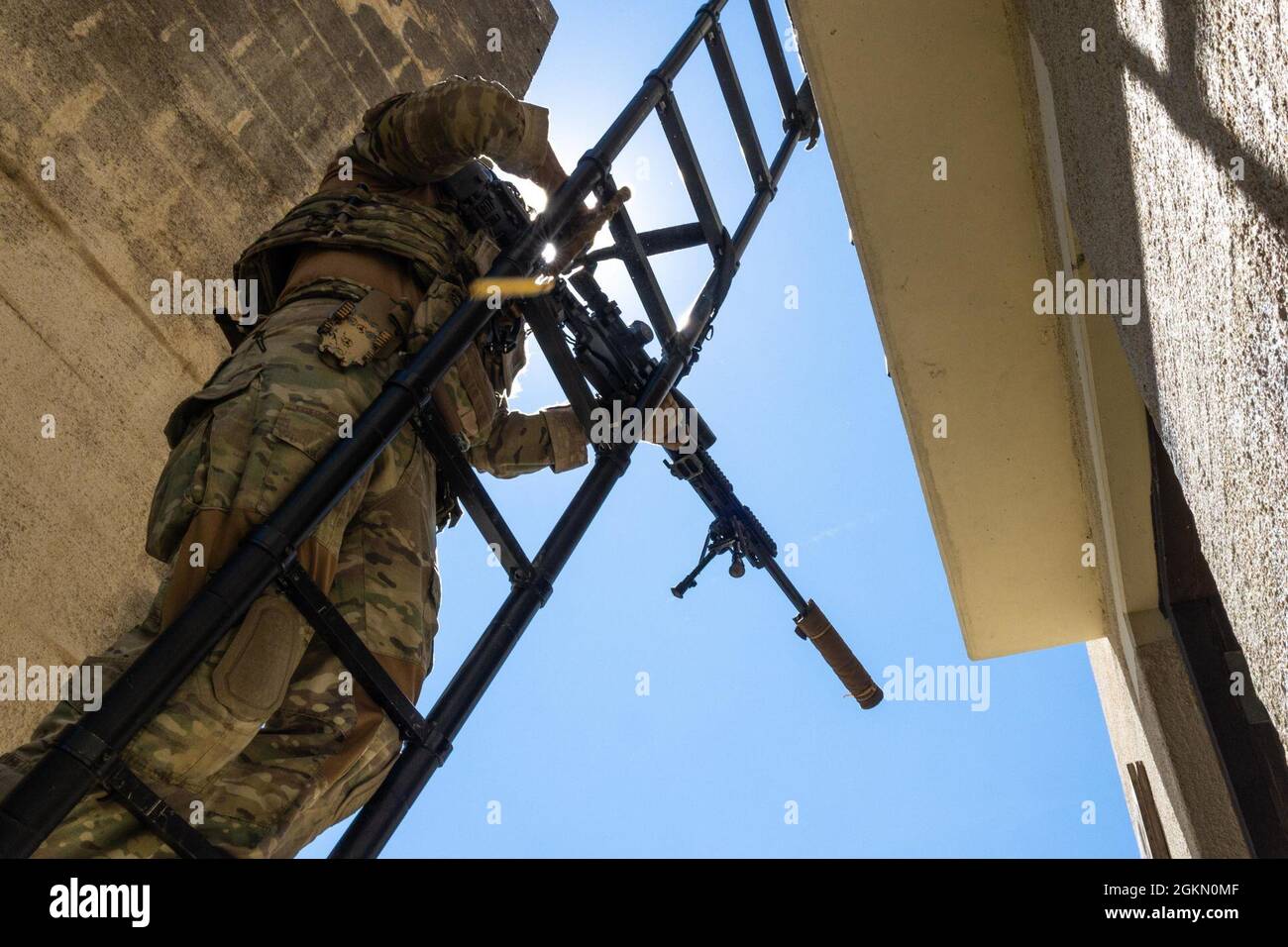 A Greek Special Forces sniper reloads his rifle while engaging a target ...
