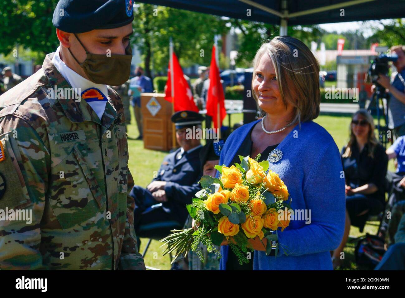 Sgt. Kelly Harper, 7th Army Training Command, presents a bouquet of ...