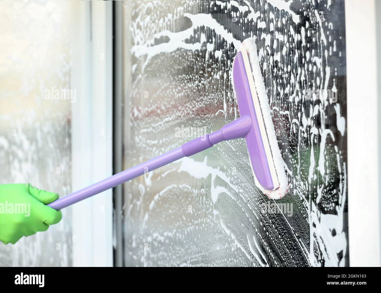 Hand of man washing window outdoors Stock Photo - Alamy