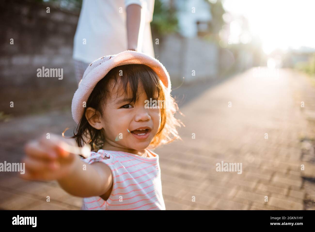 kid stick her arm out asking to walk together Stock Photo - Alamy