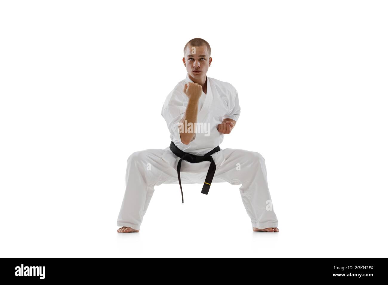 Full-length portrait of caucasian sportsman standing in a fight pose ...