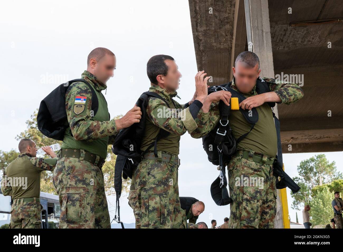 Serbian Special Operations Forces don their parachutes during a ...
