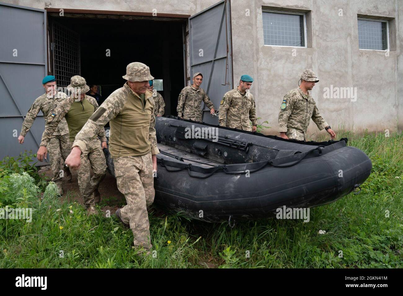Ukrainian Marines with the 36th Marine Brigade practice carrying a ...