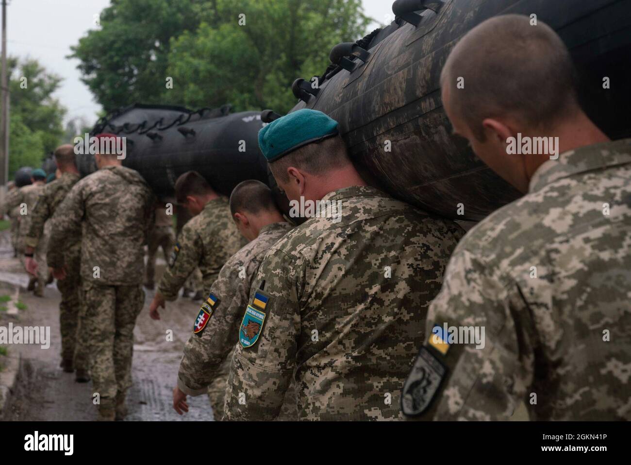 Ukrainian Marines with the 36th Marine Brigade carry a combat rubber reconnaissance craft (CRRC ...