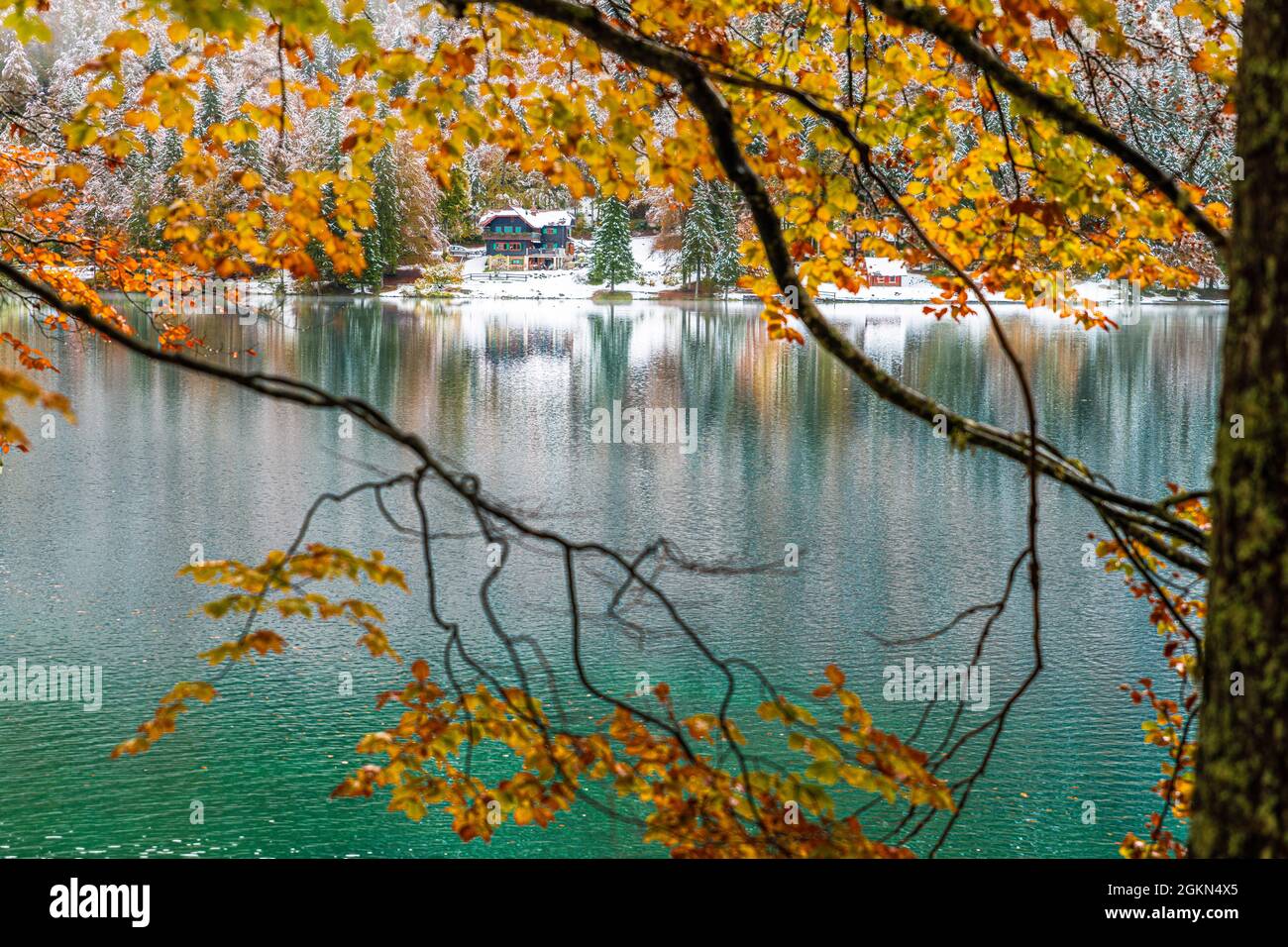 Between autumn and winter. Warm and cold reflections of snow on Lake ...
