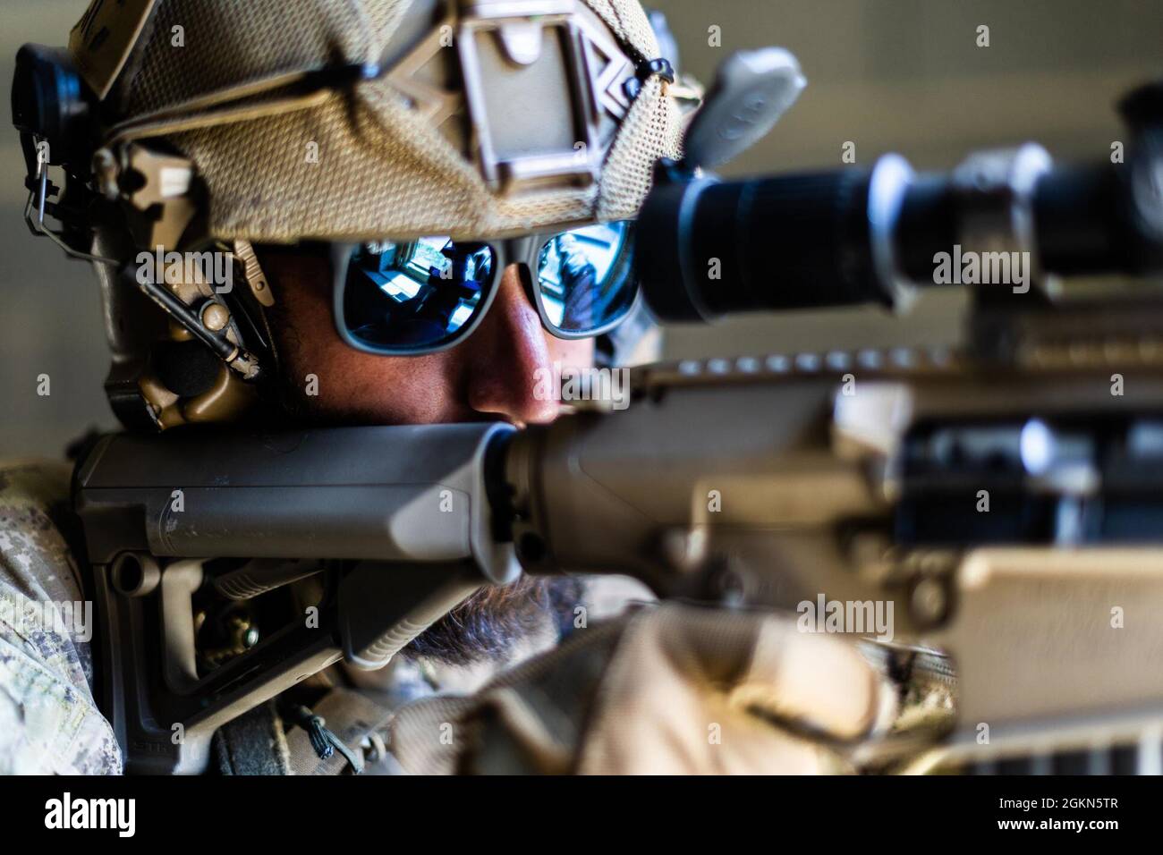An Italian Special Forces sniper engages a target at the International ...