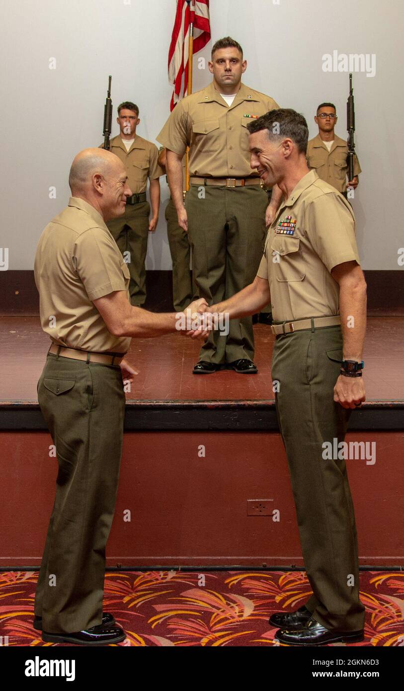 U.S. Marine Corps Col. Gilbert D. Juarez, outgoing commanding officer, 3d Marines, shakes hands ...