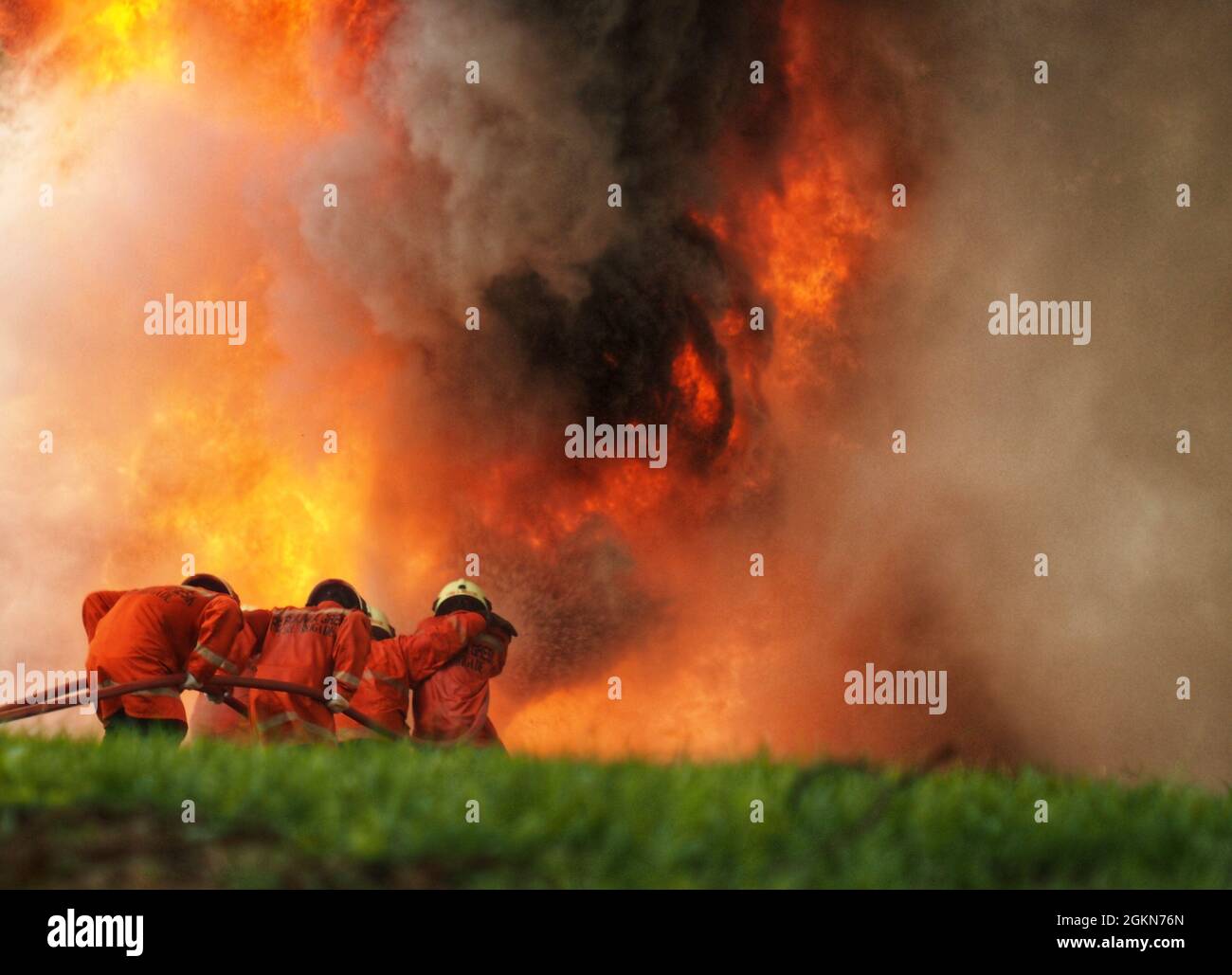 Firefighters are struggling to put out the fire Stock Photo - Alamy