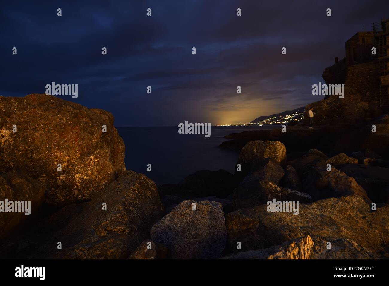 suggestive view through the rocks of the sea in the evening Stock Photo ...