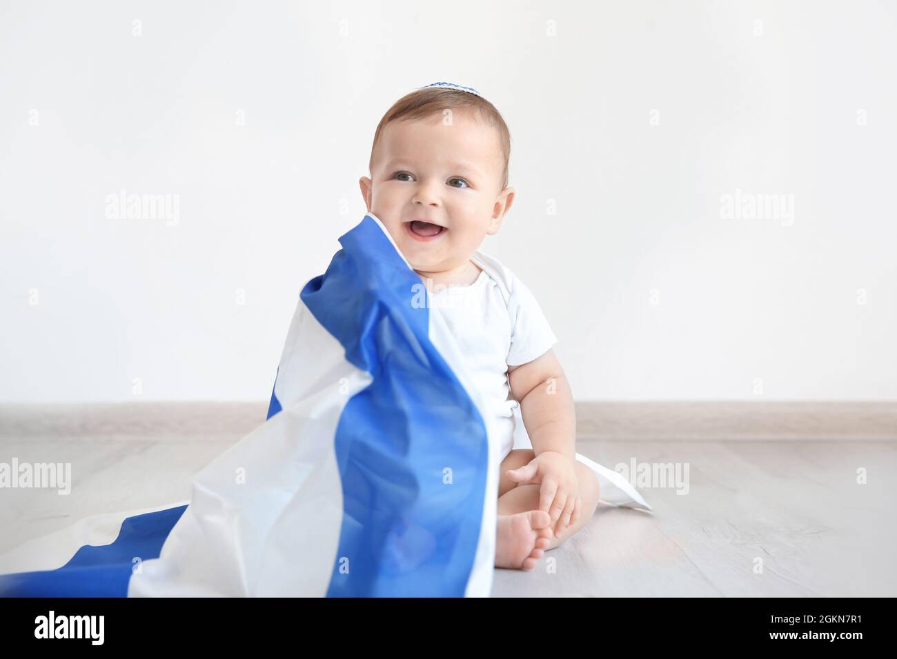 Cute baby with flag of Israel sitting on floor at home Stock Photo - Alamy
