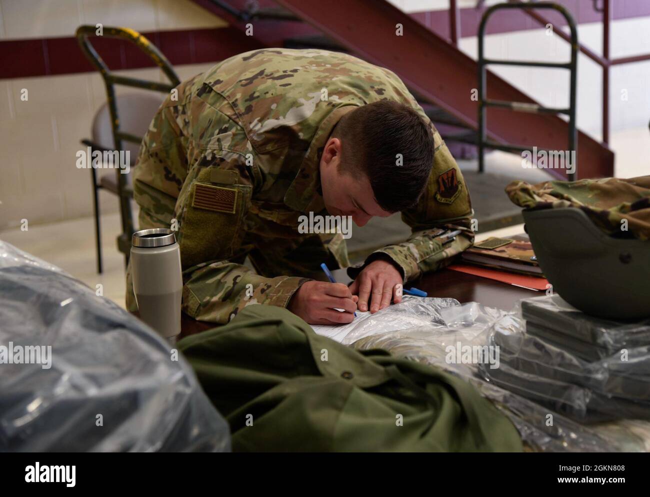 Members of the 110th Wing sign for gear they are issued while taking ...