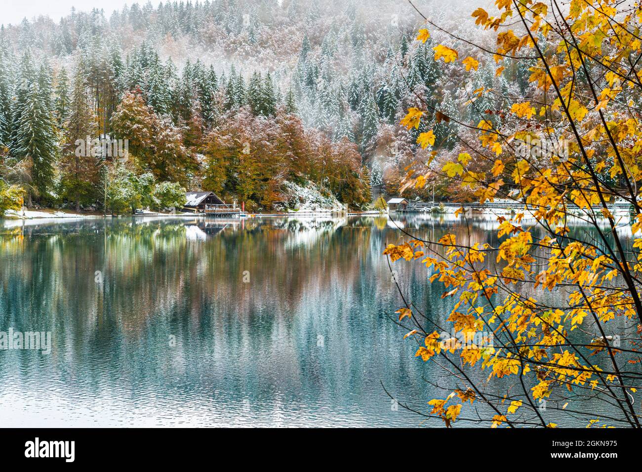 Between autumn and winter. Warm and cold reflections of snow on Lake ...