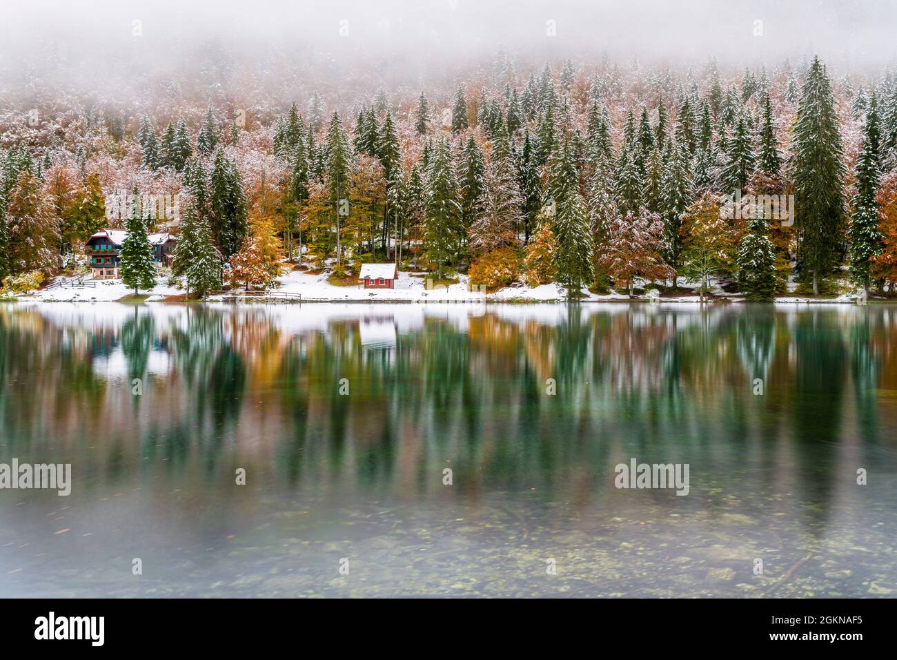 Between autumn and winter. Warm and cold reflections of snow on Lake ...