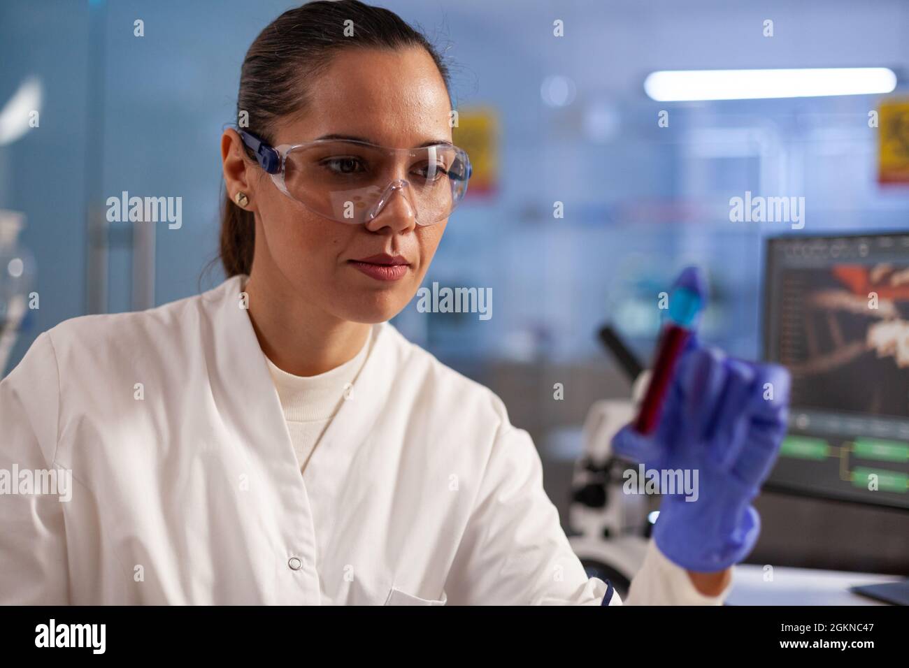 Medical researcher scientist analyzing blood jar sample for development ...
