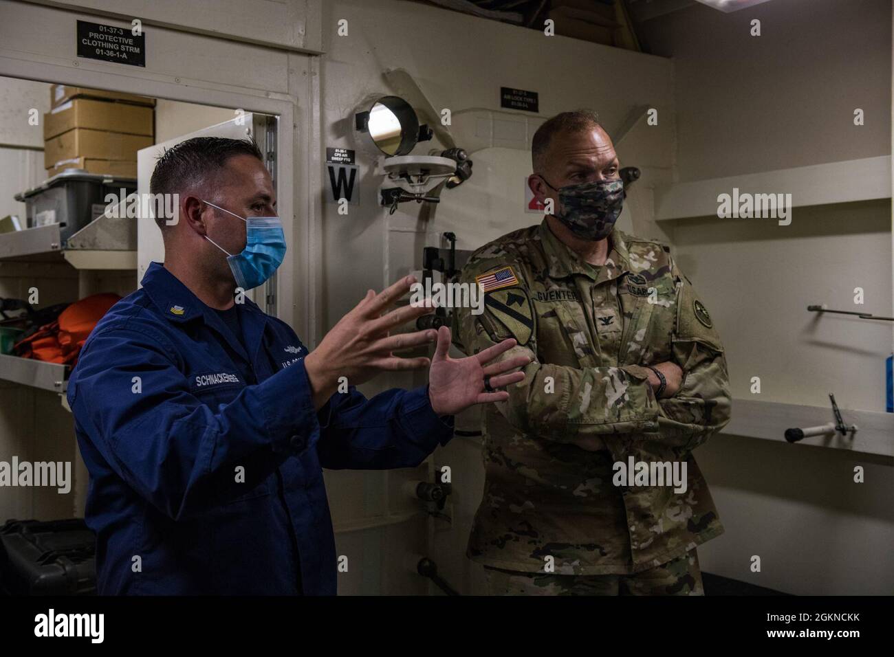 U.S. Coast Guard Damage Controlman 1st Class Ronald Schnackenberg, left ...