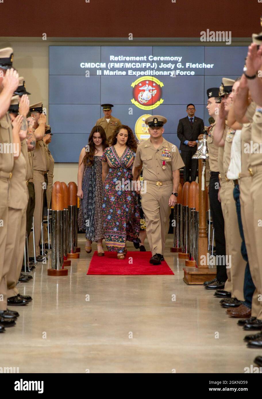 U.S. Navy Master Chief Petty Officer Jody Fletcher walks through an ...