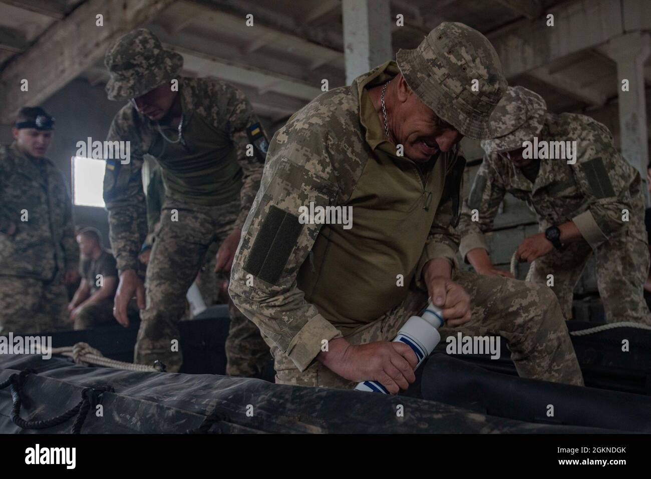 Ukrainian Marines with the 36th Marine Brigade assemble a combat rubber ...