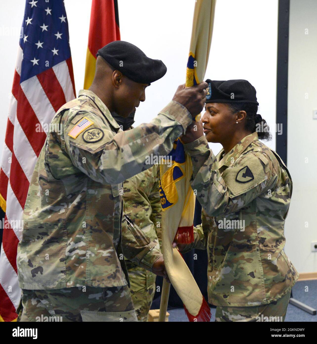 U.S. Army Command Sgt. Maj. Kimala D. Cox passes the unit colors to Col. Freddy L. Adams II ...