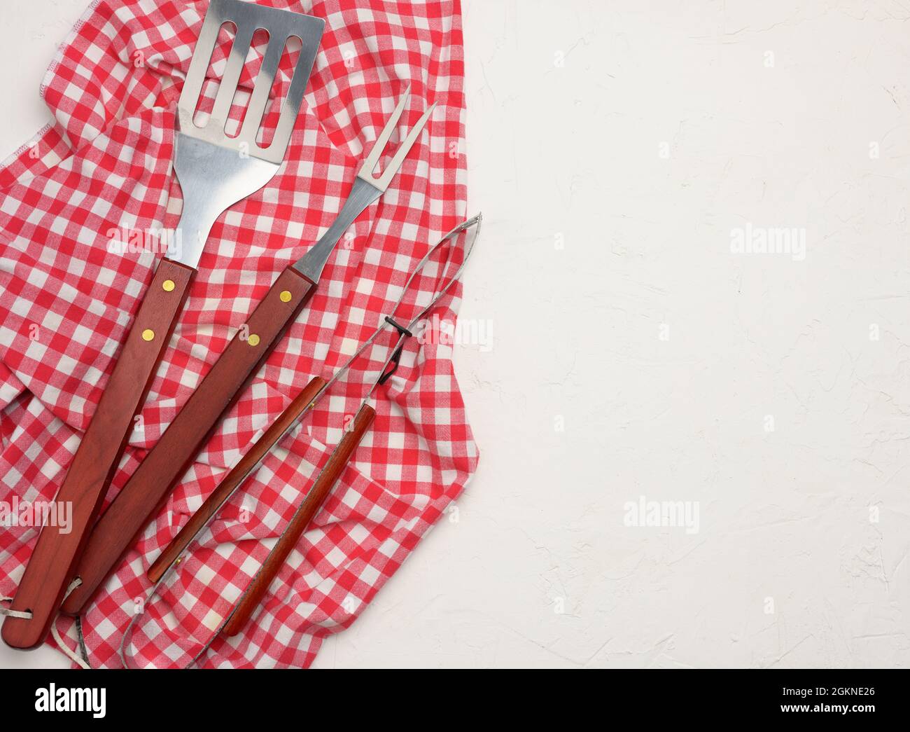 metal kitchen items with wooden handles for barbecue on white ...