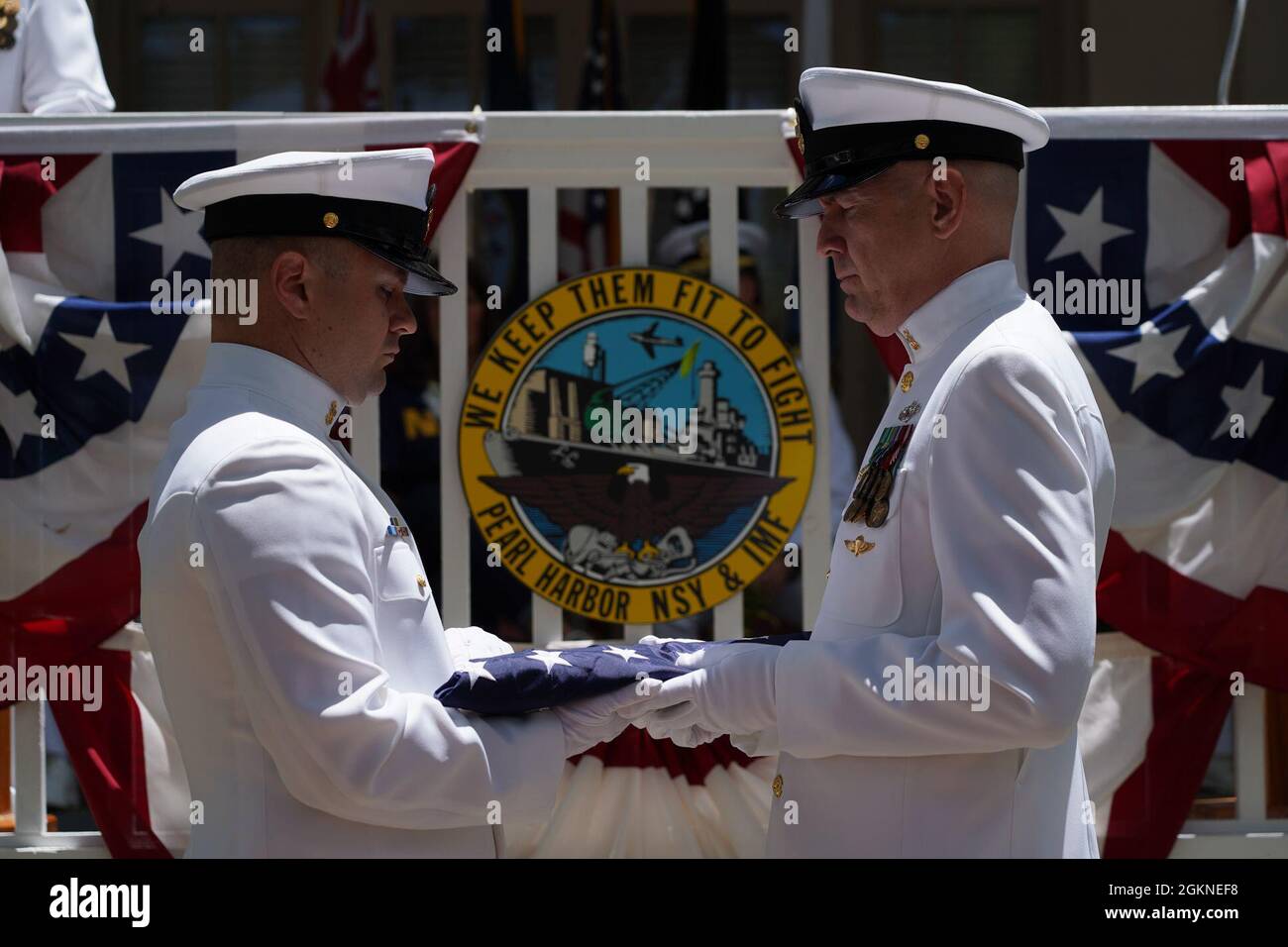 Chief David E. Wilson and Chief Joseph D. Rogers perform a flag folding ...