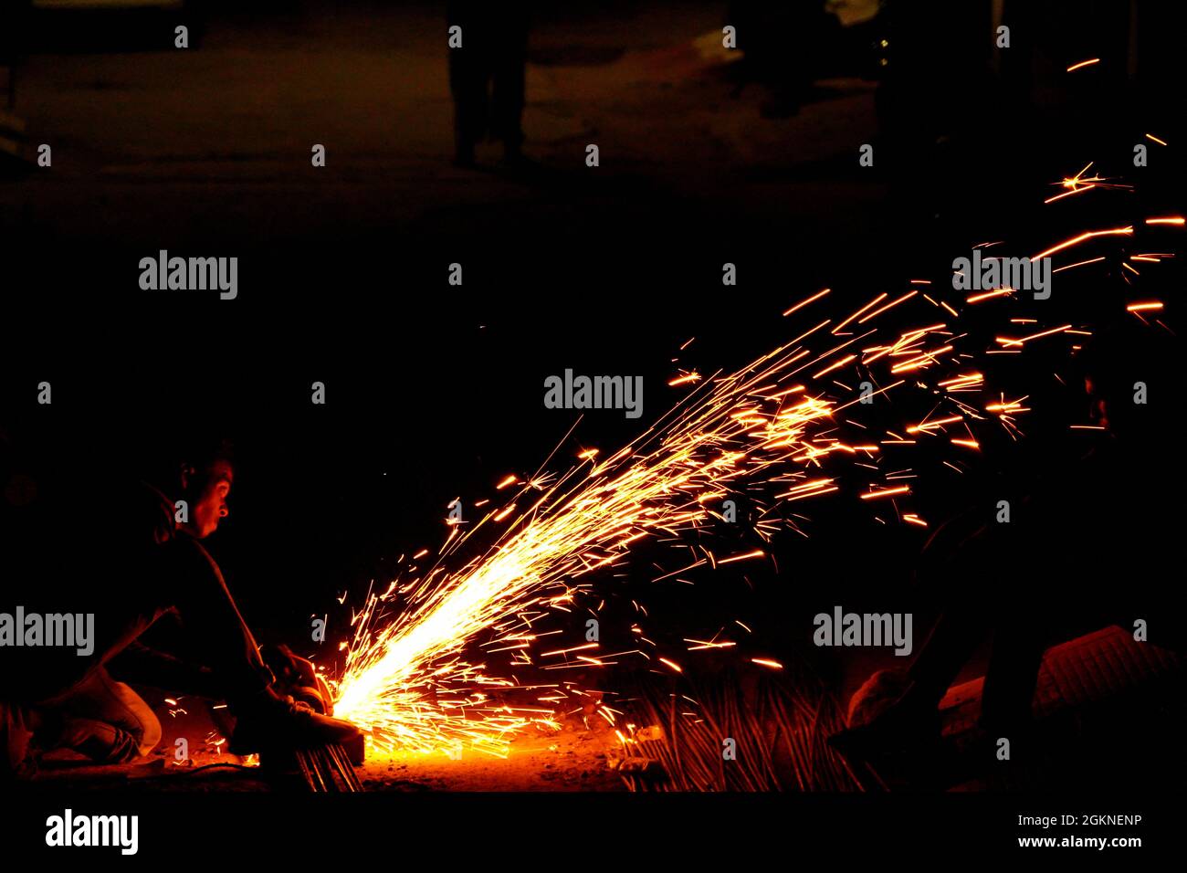 Indian worker cutting iron using grinder on the construction site in ...