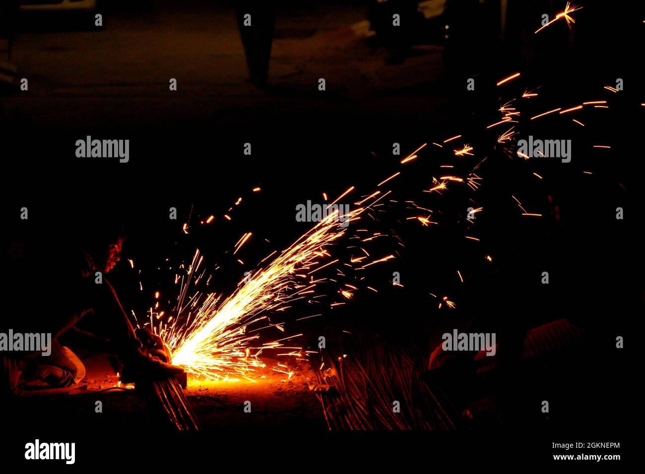 Indian worker cutting iron using grinder on the construction site in ...