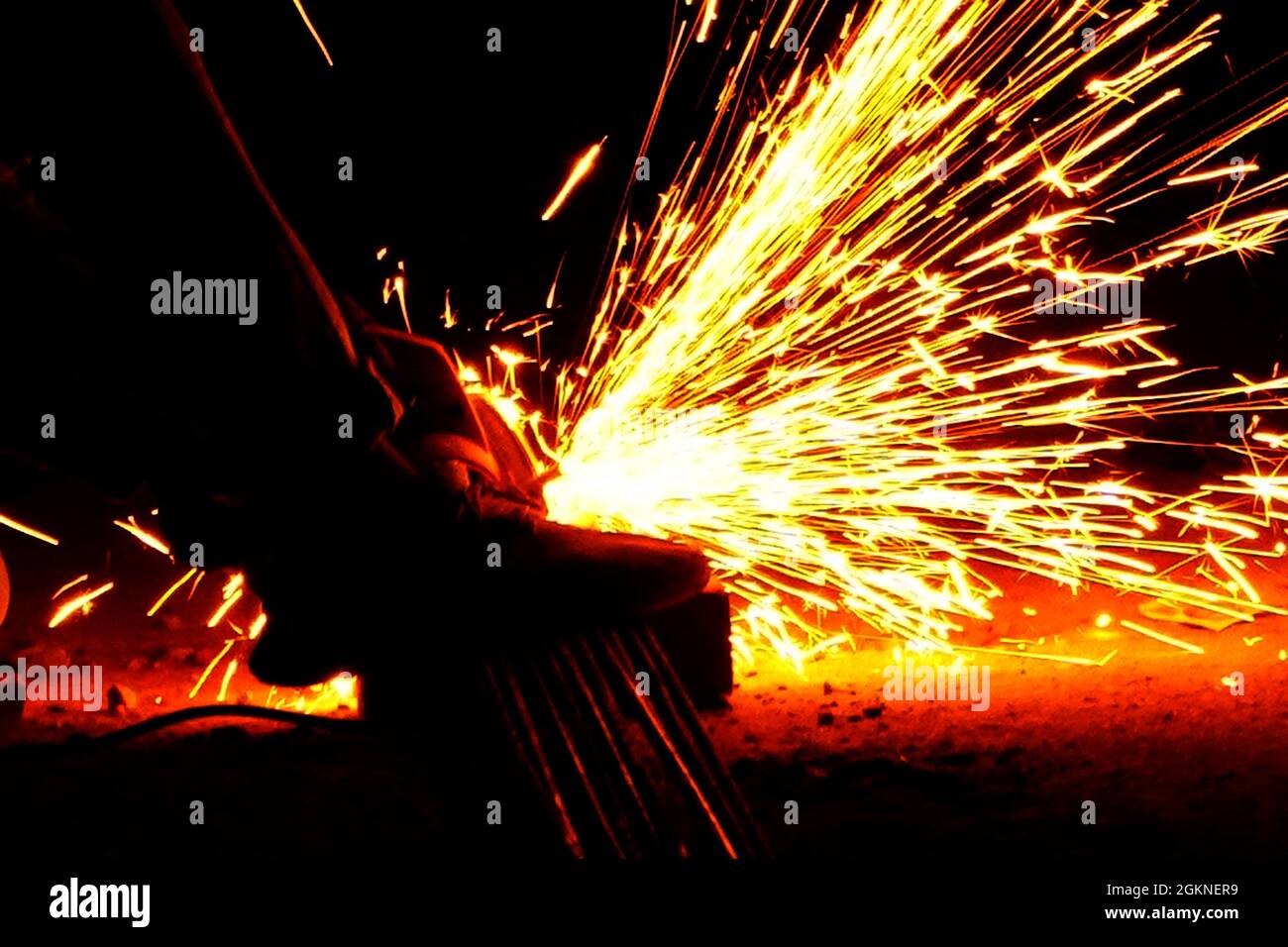 Indian worker cutting iron using grinder on the construction site in ...