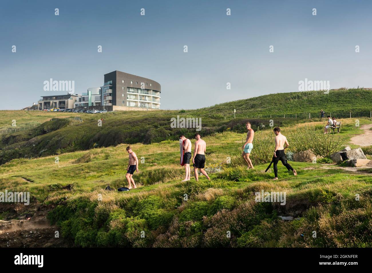 A group of young male holidaymakers preparing to jump off rocks at ...