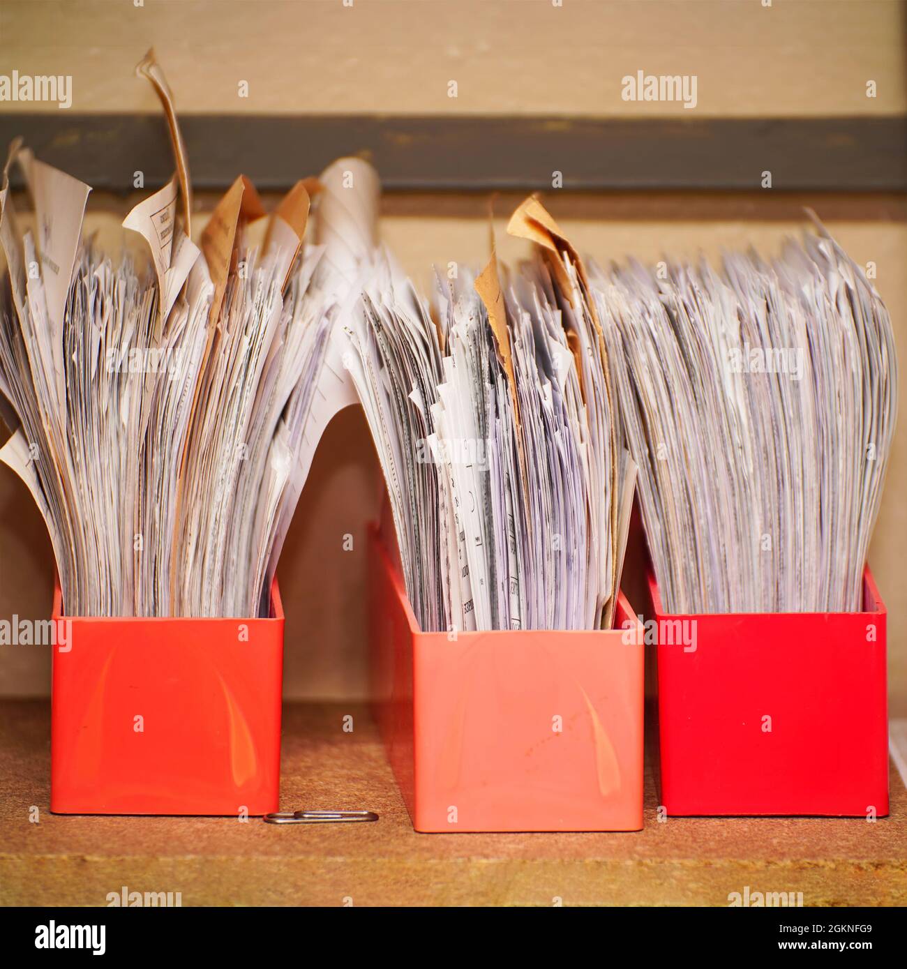 Old documents and business papers in boxes on a shelf in the archive ...