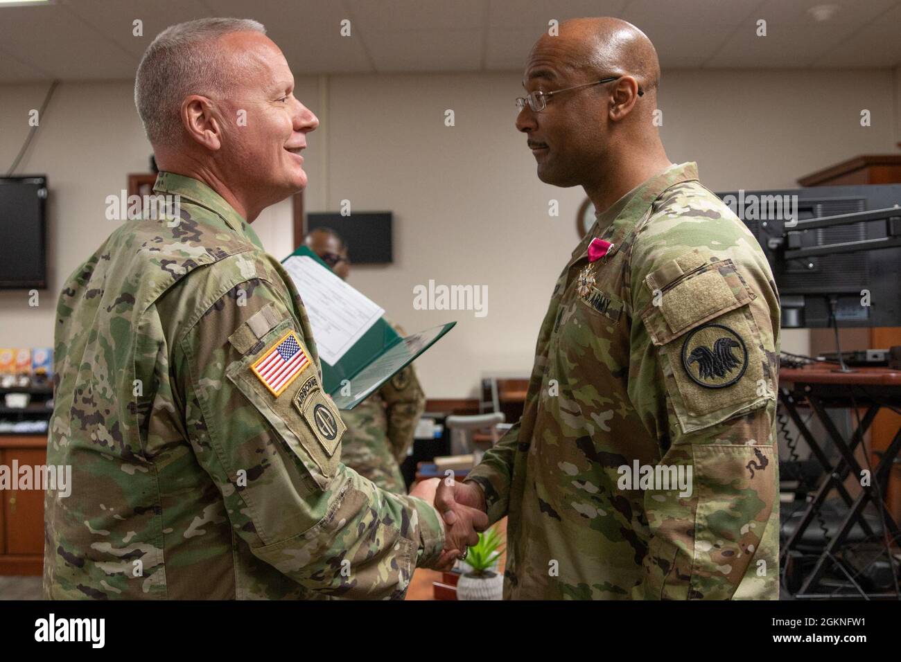Command Sgt. Maj. Michael Robinson (right) is awarded the Legion of ...