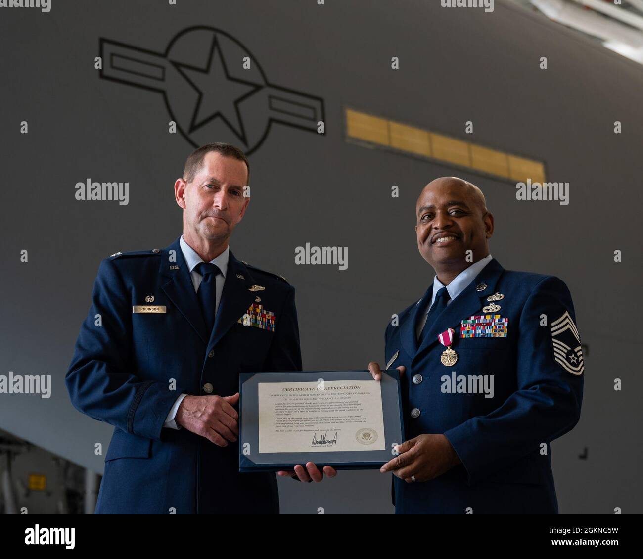 Col. John F. Robinson, 911th Airlift Wing commander, presents a ...