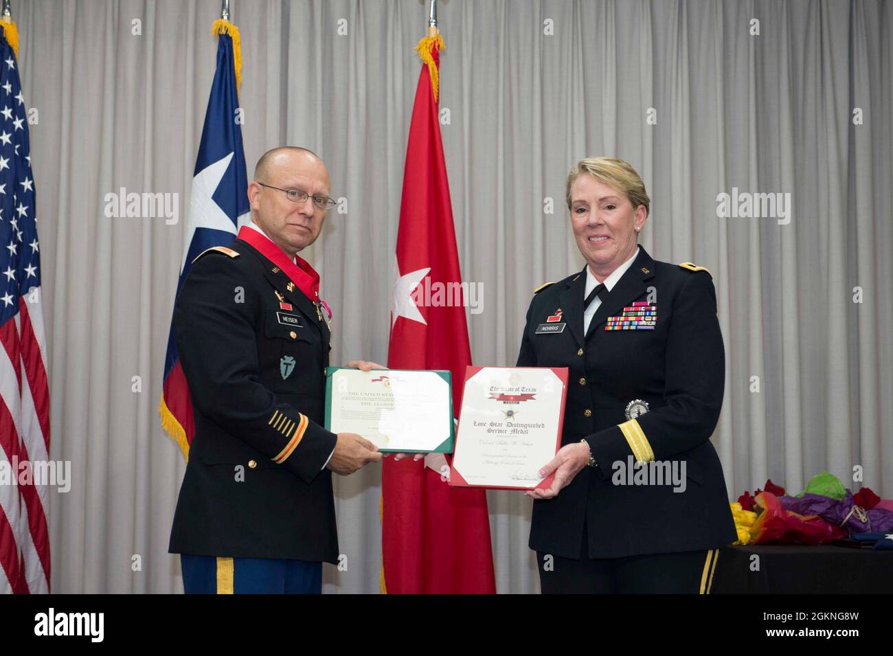Col. Billie Heiser is presented an award by Maj. Gen. Tracey Noris, the ...