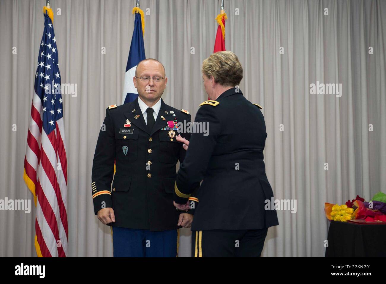 Col. Billie Heiser is presented an award by Maj. Gen. Tracey Noris, the ...