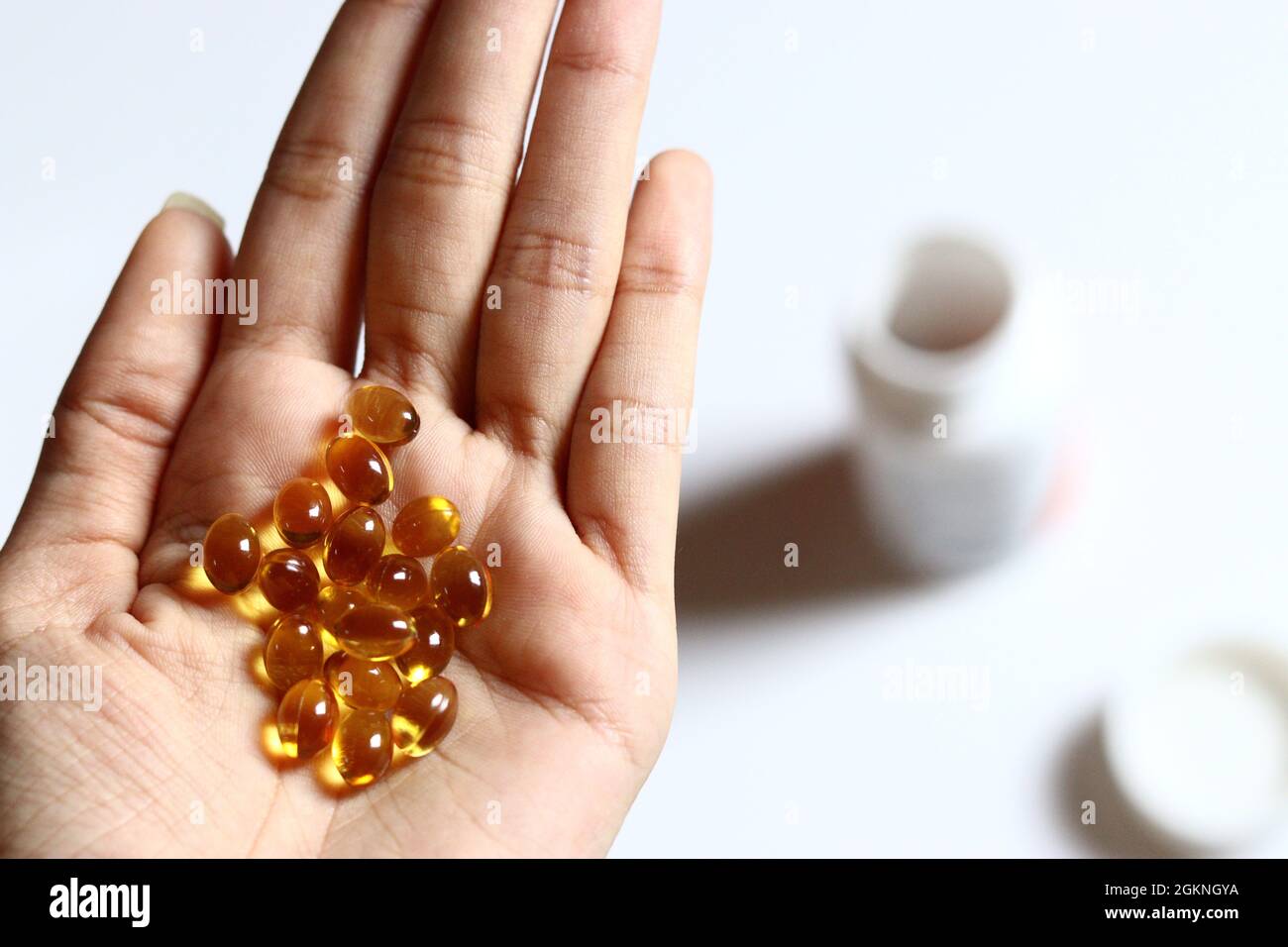 Vitamin D supplements on the palm of a female hand Stock Photo - Alamy