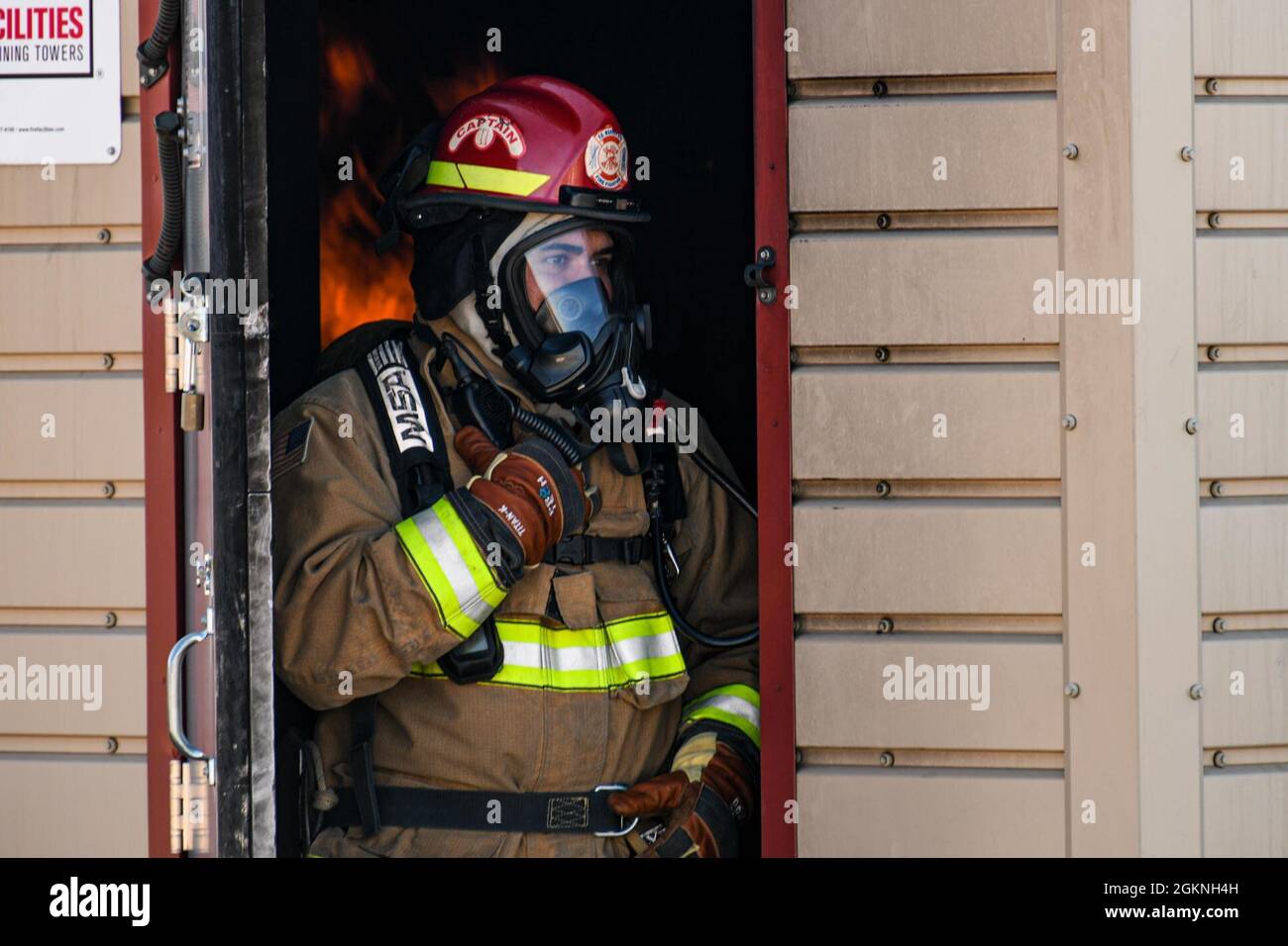 A firefighter assigned to the 90th Civil Engineer Squadron steps out ...