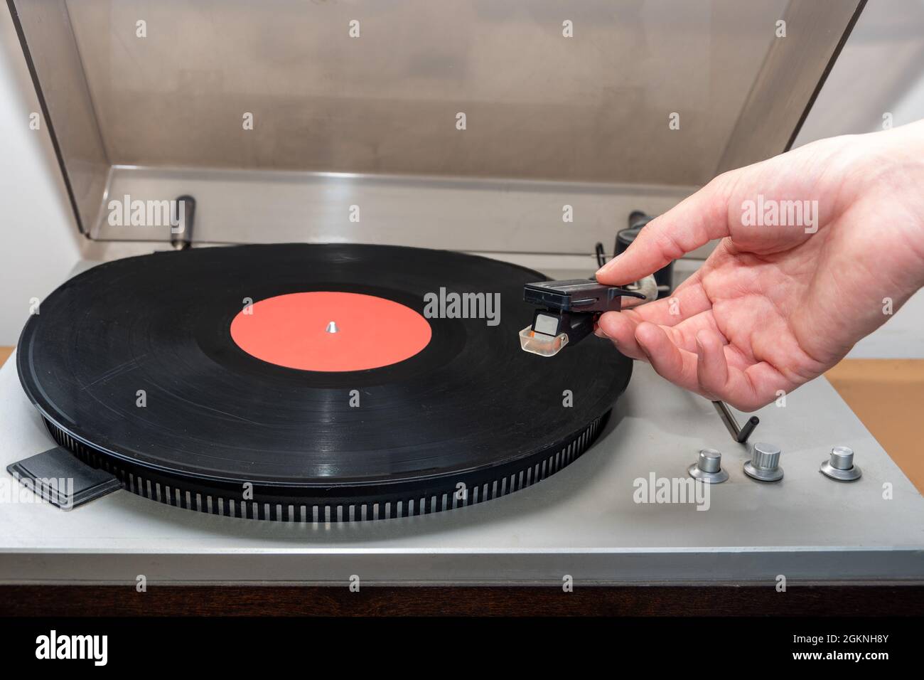 Hand turning on stereo turntable analog retro vintage. An old-fashioned ...