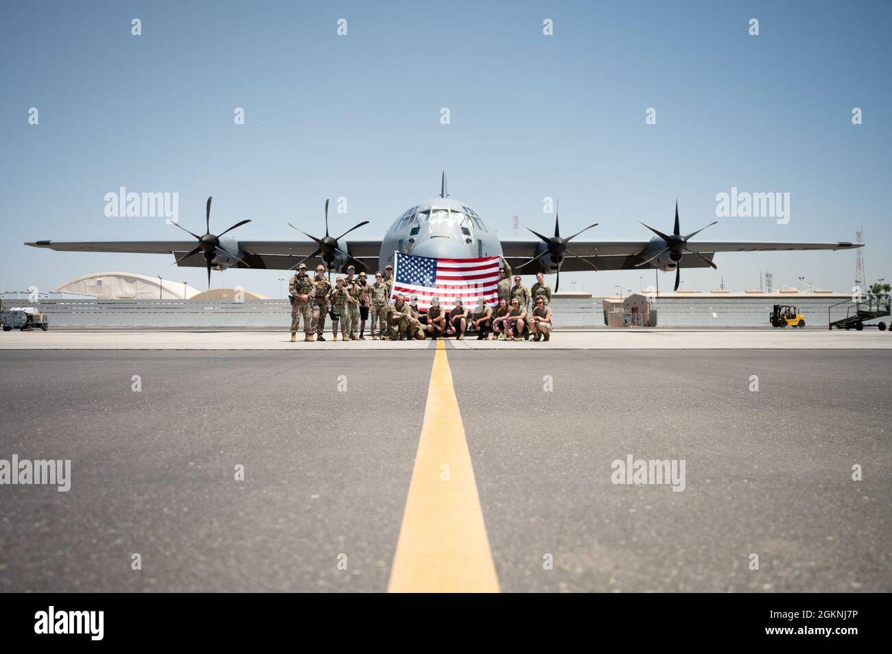 Members of the 75th Expeditionary Airlift Squadron display an American ...