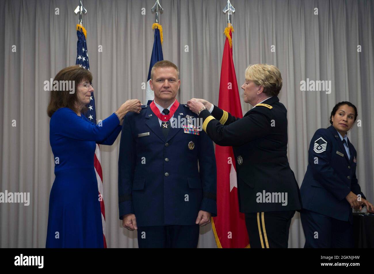 Mark Gaul is pined with stars by his wife (left) and Maj. Gen. Tracey ...