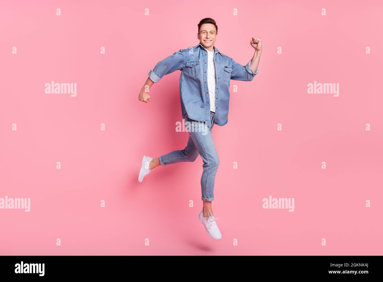 Full size photo of young smiling handsome guy running in air traveling ...