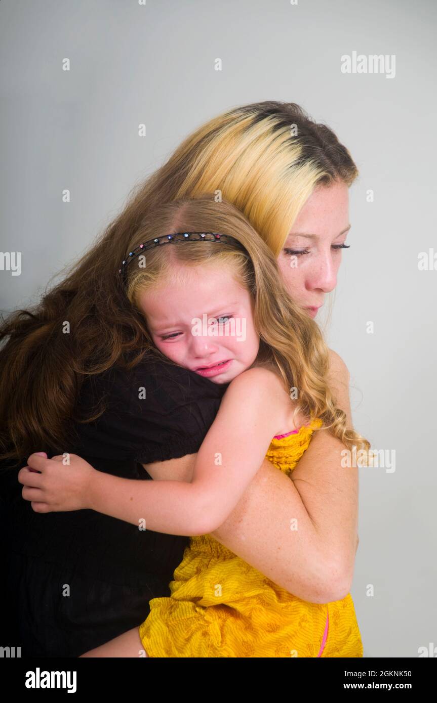 Mother comforts her crying daughter Stock Photo - Alamy