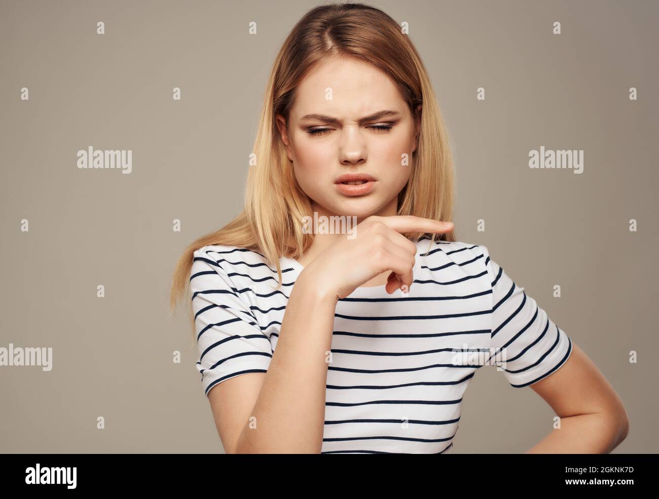 pretty woman striped t-shirt gesture hands emotions stress anger Stock ...