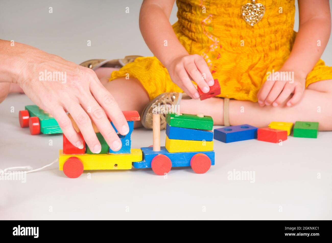 Mother and daughter of 3 play with building blocks Stock Photo - Alamy