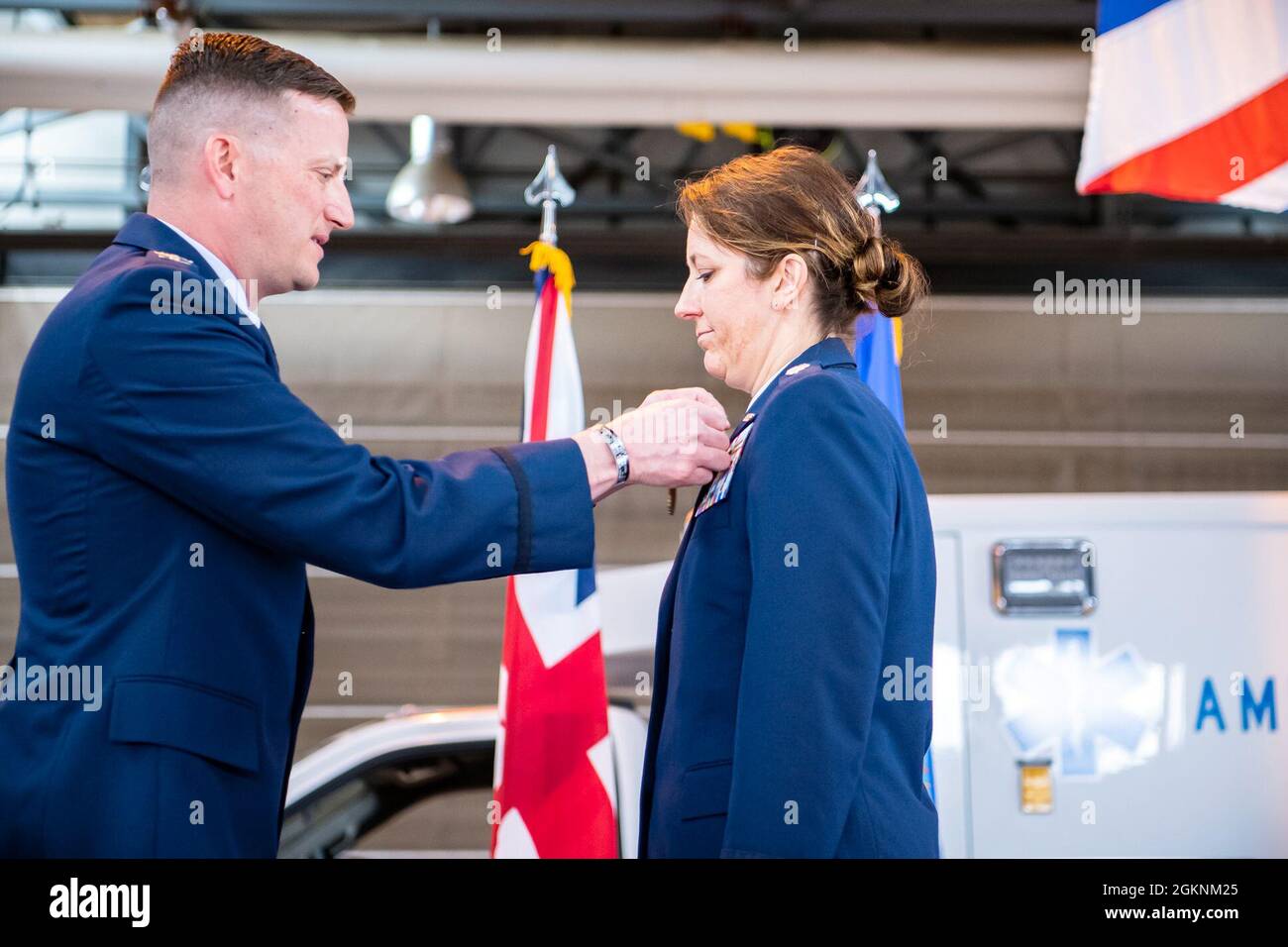 U.S. Air Force Col. Richard Martin, left, 423rd Air Base Group commander, pins a Meritorious ...